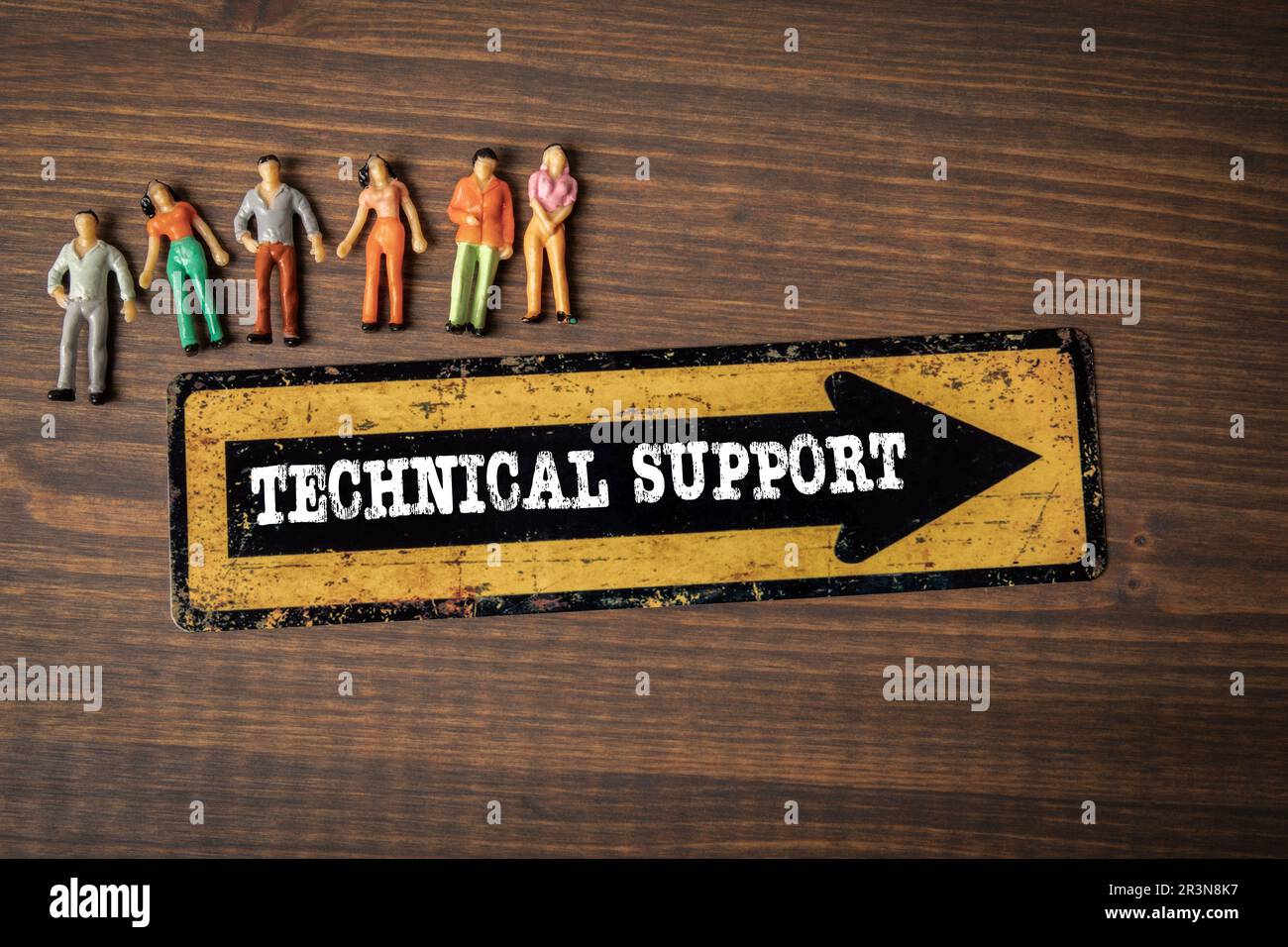 Technical Support. Direction arrow and miniature human figures on a ...
