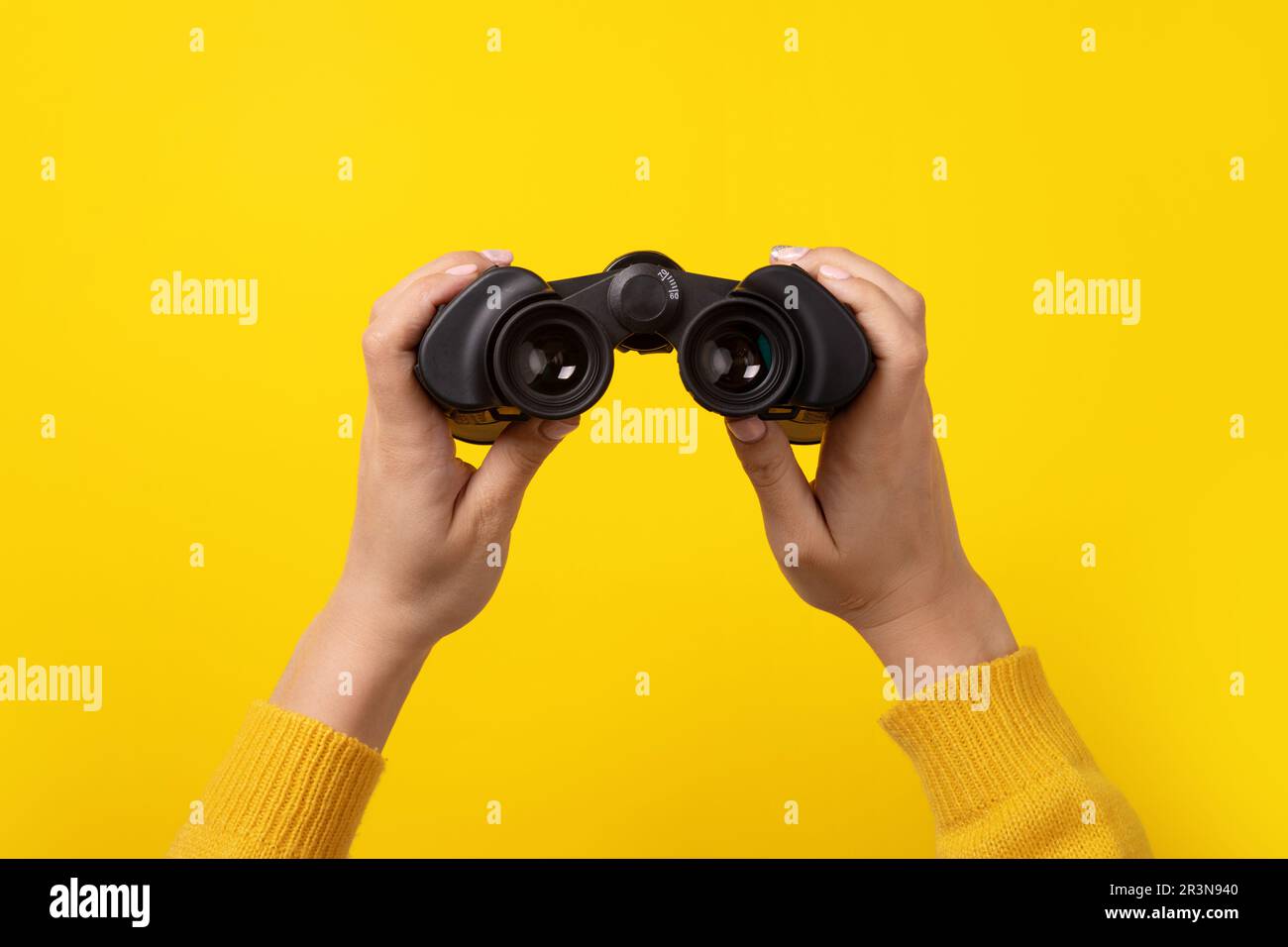 Binoculars in hand Stock Photo - Alamy