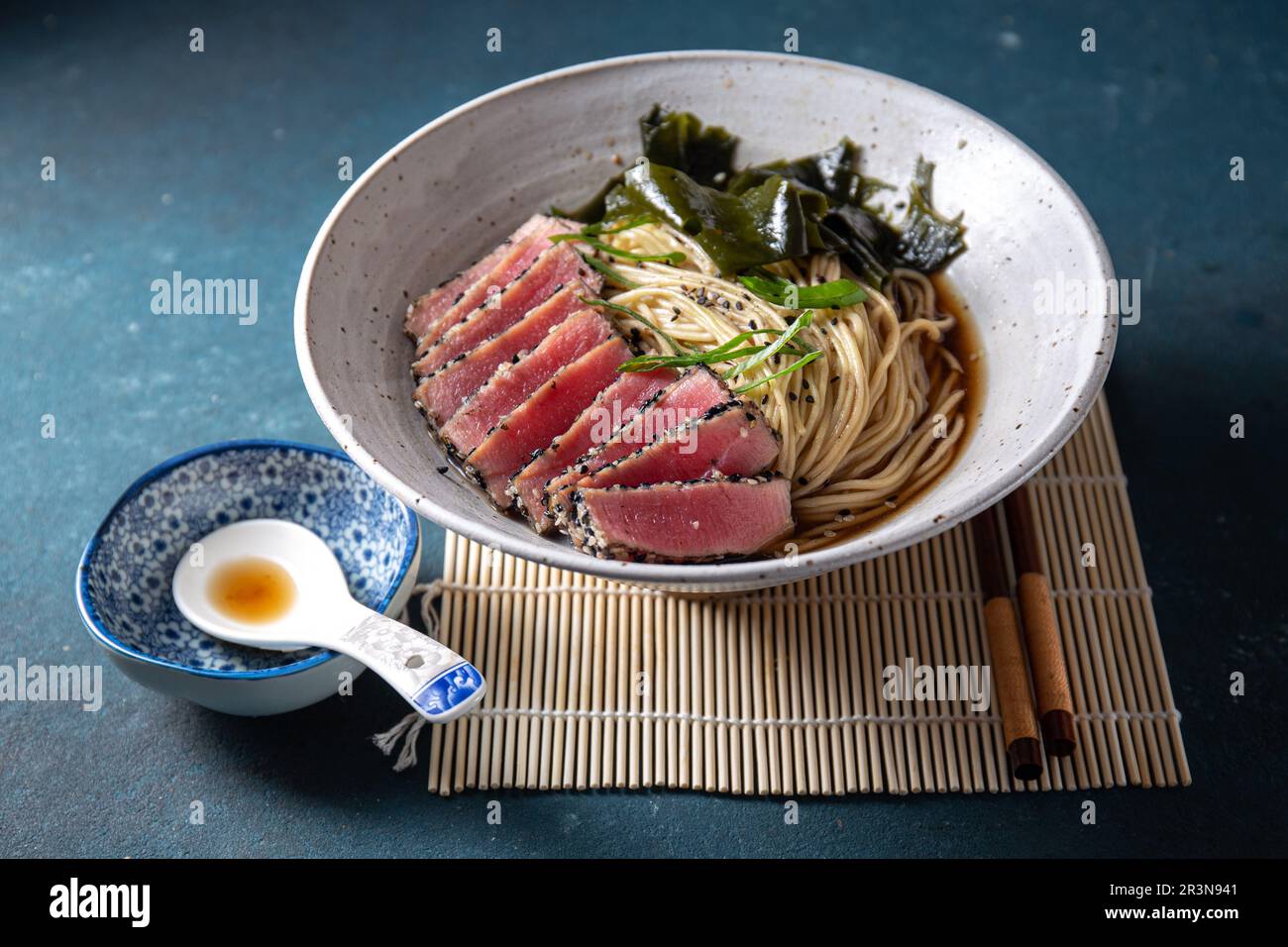 Tuna steak ramen. Japanese soup with noodles ramen, miso, fried tuna steak and seaweed algae ...