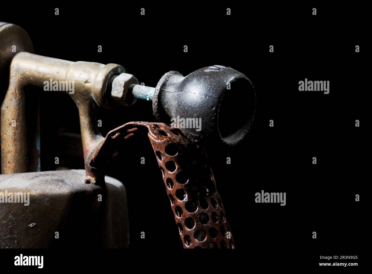 old and vintage blow torch isolated on black background with rust and ...