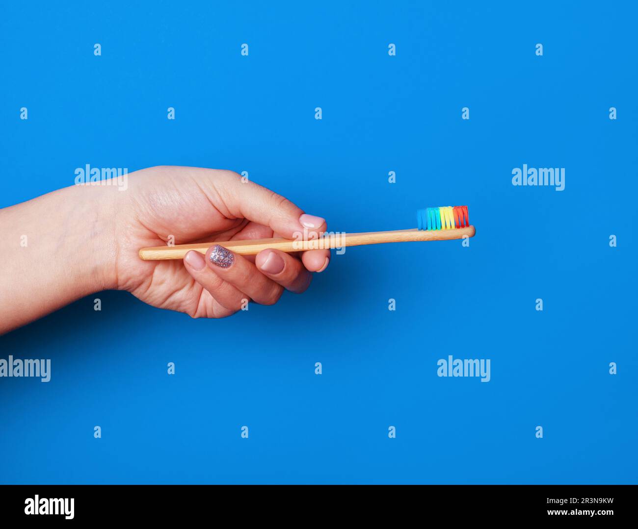 Bamboo toothbrush in hand Stock Photo - Alamy