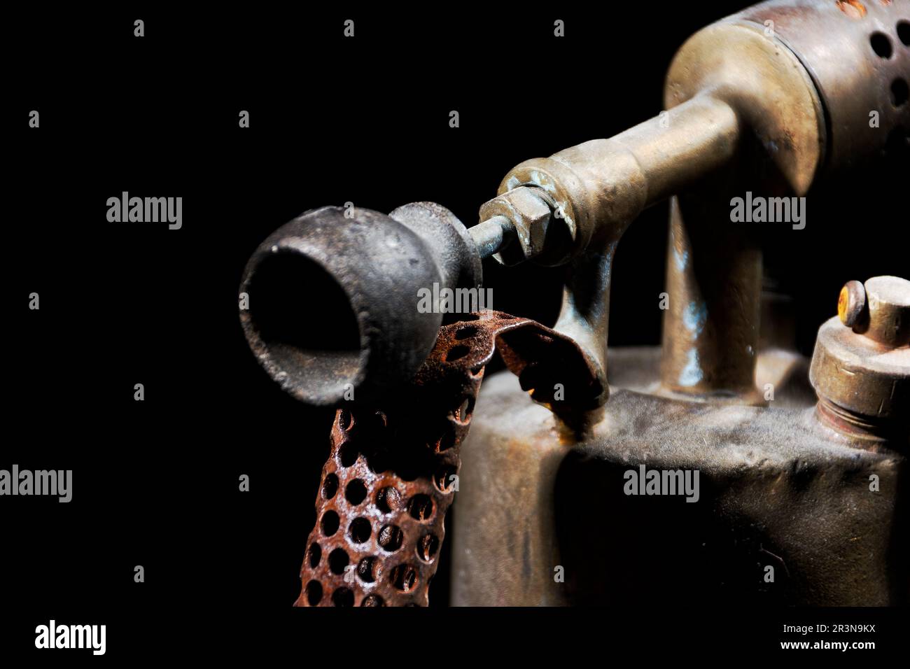 old and vintage blow torch isolated on black background with rust and ...