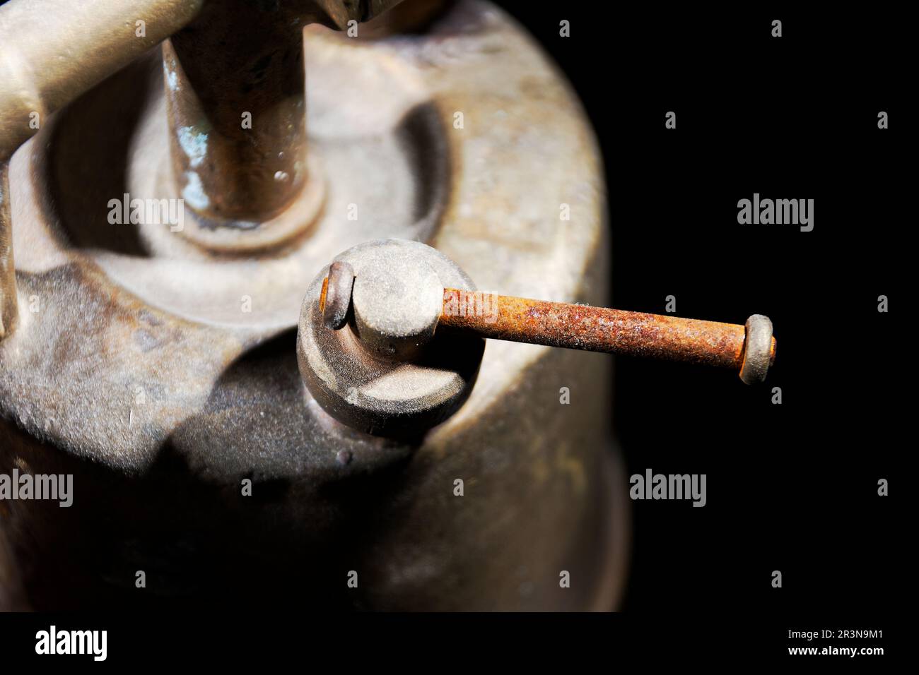 old and vintage blow torch isolated on black background with rust and ...