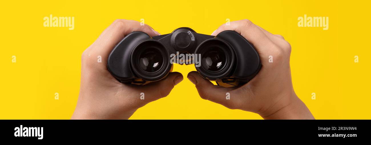 Binoculars in hand panoramic Stock Photo - Alamy