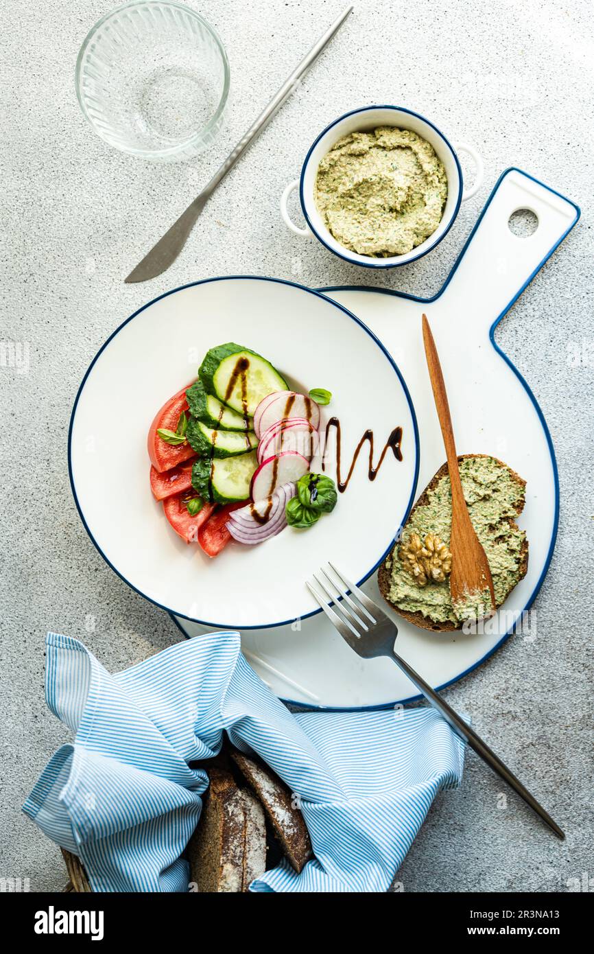 From above healthy lunch with vegetable salad and toasts with walnut ...