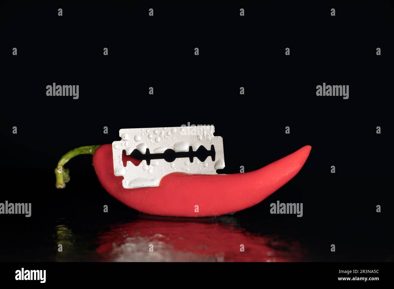 Red chili pepper an razor blade Stock Photo - Alamy