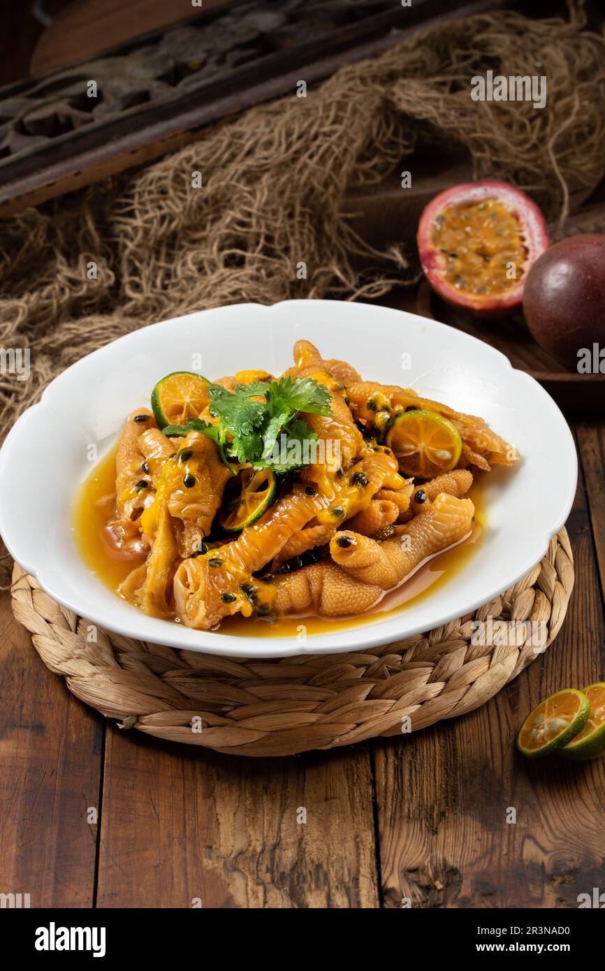 Chicken feet with Passion Fruit hot Pepper on retro dark background ...