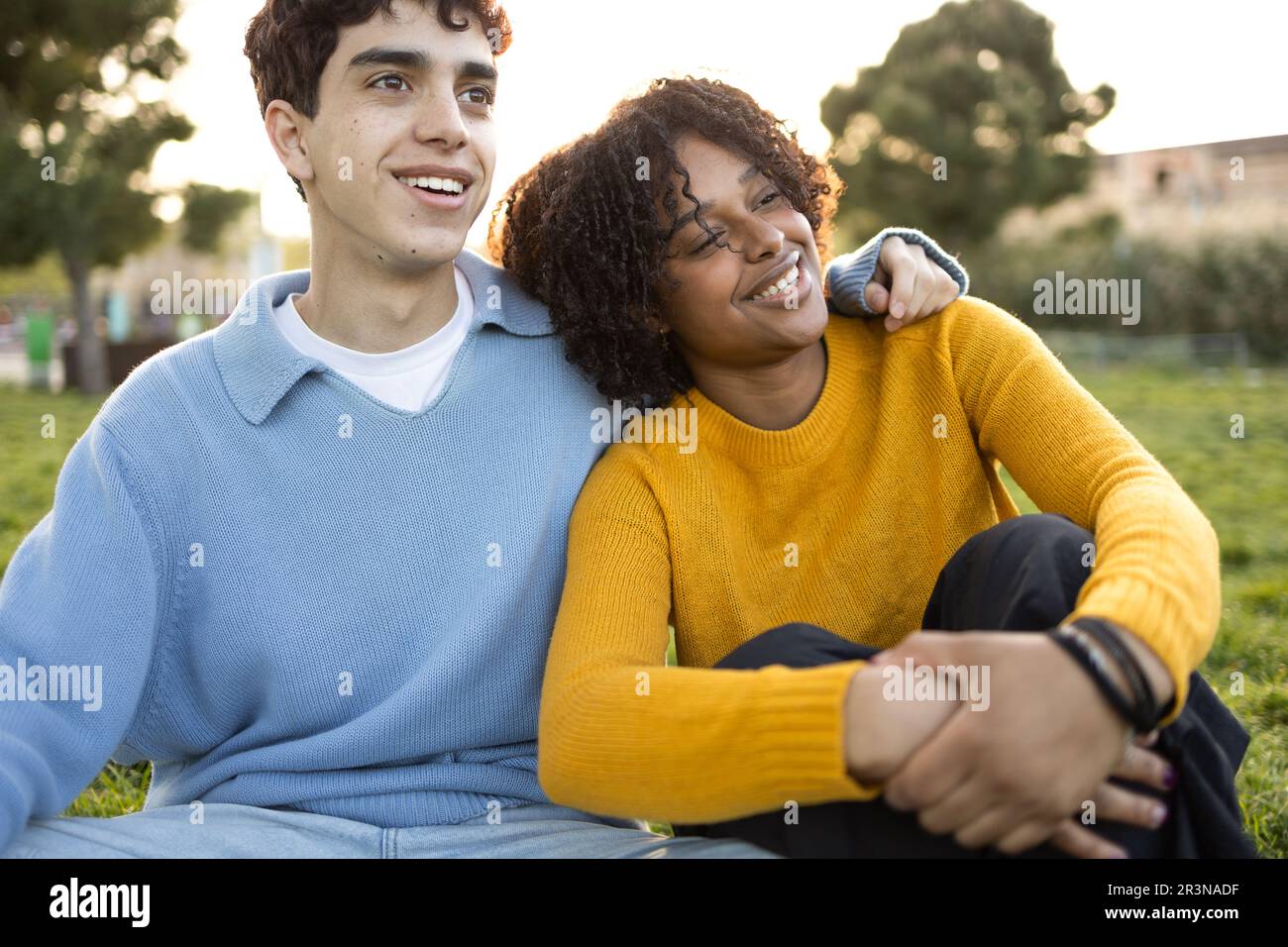 Front view of smiling multiracial young female and male friends while ...