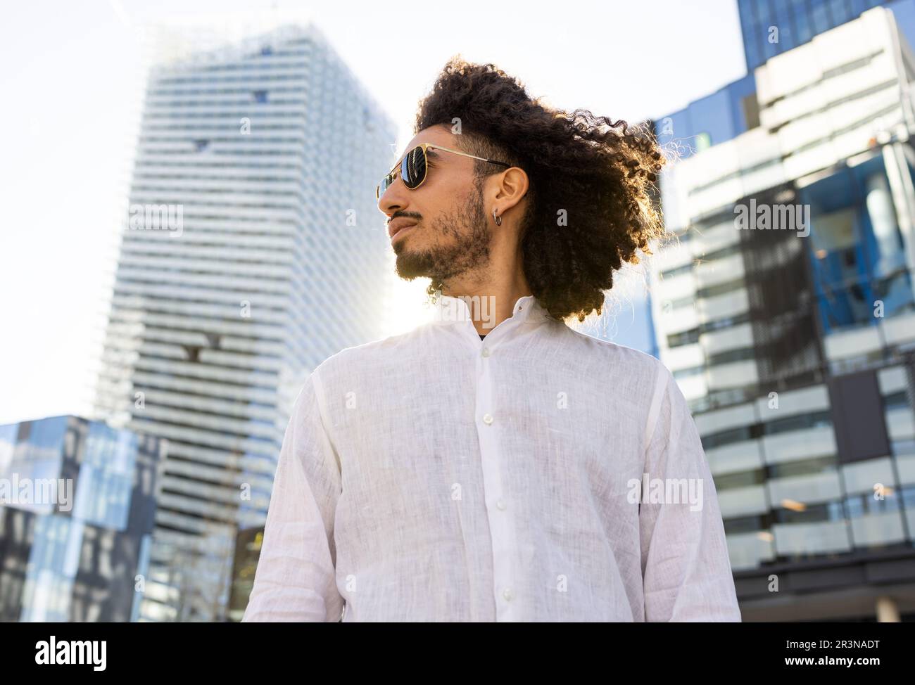 From below African American man with modern clothes afro hairstyle and ...