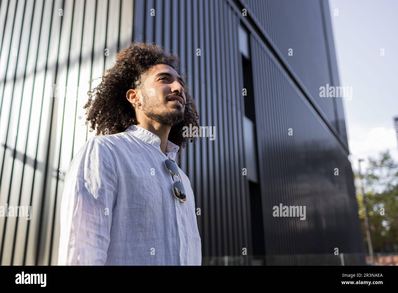 From below side view of a happy African American man in casual clothes ...