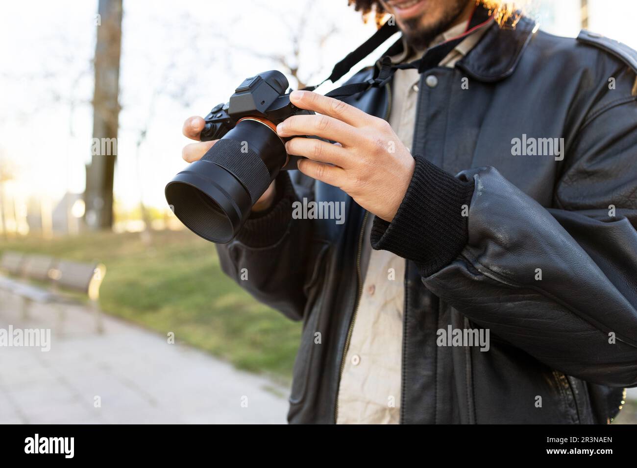 Happy anonymous person taking a photo with a modern camera while ...