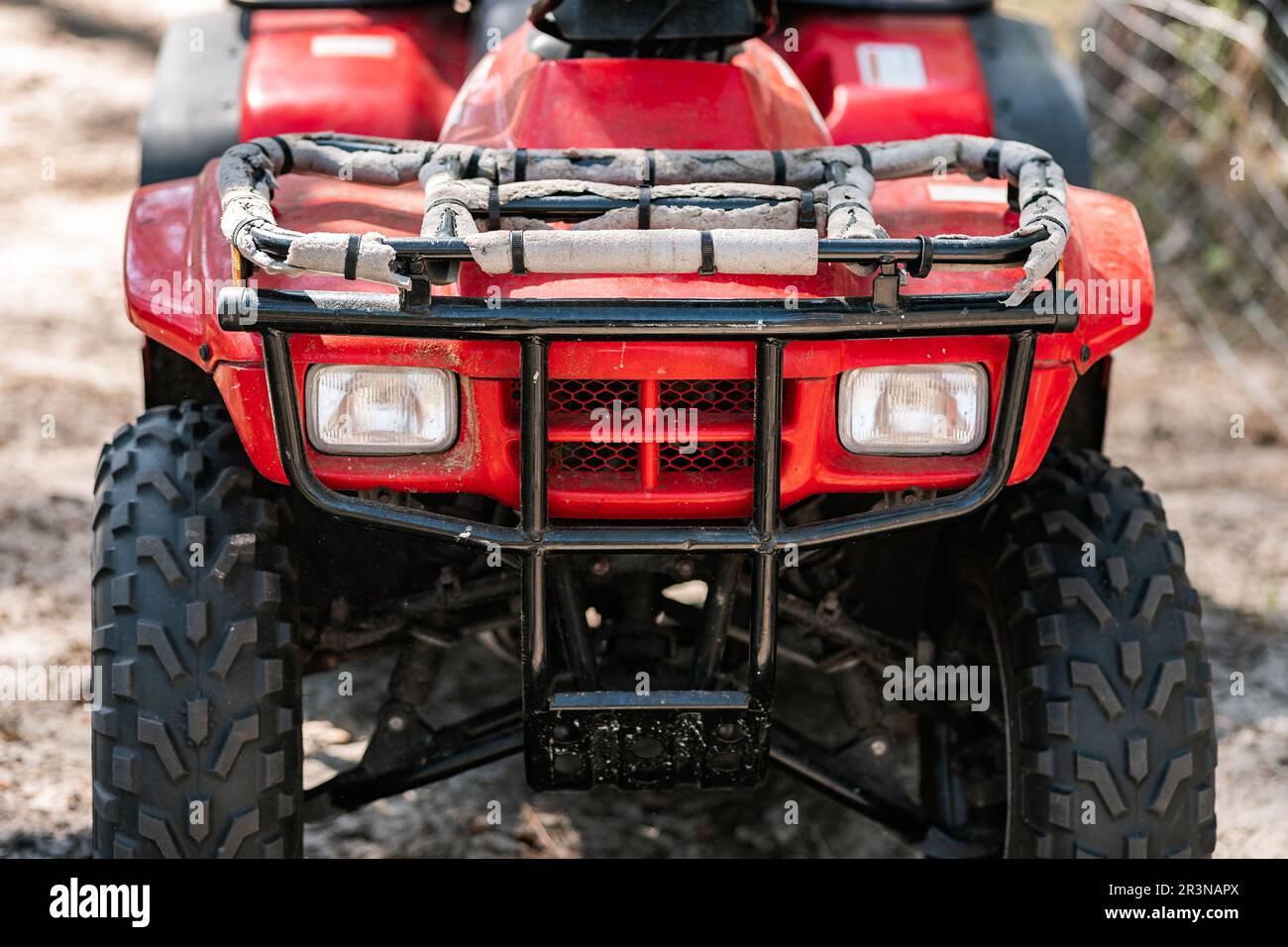 Front park of red ride on car with bumper on ground in sunny amusement ...