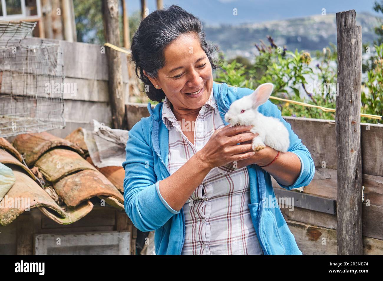 Positive mature Latin American female farmer with dark hair in casual ...