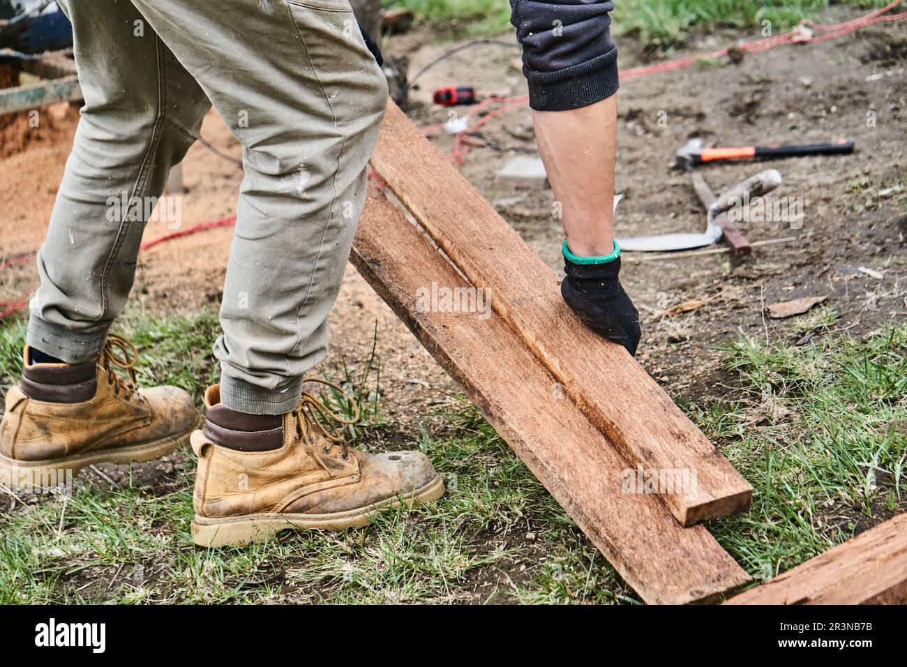 From above of crop unrecognizable male carpenter in casual wear boots ...