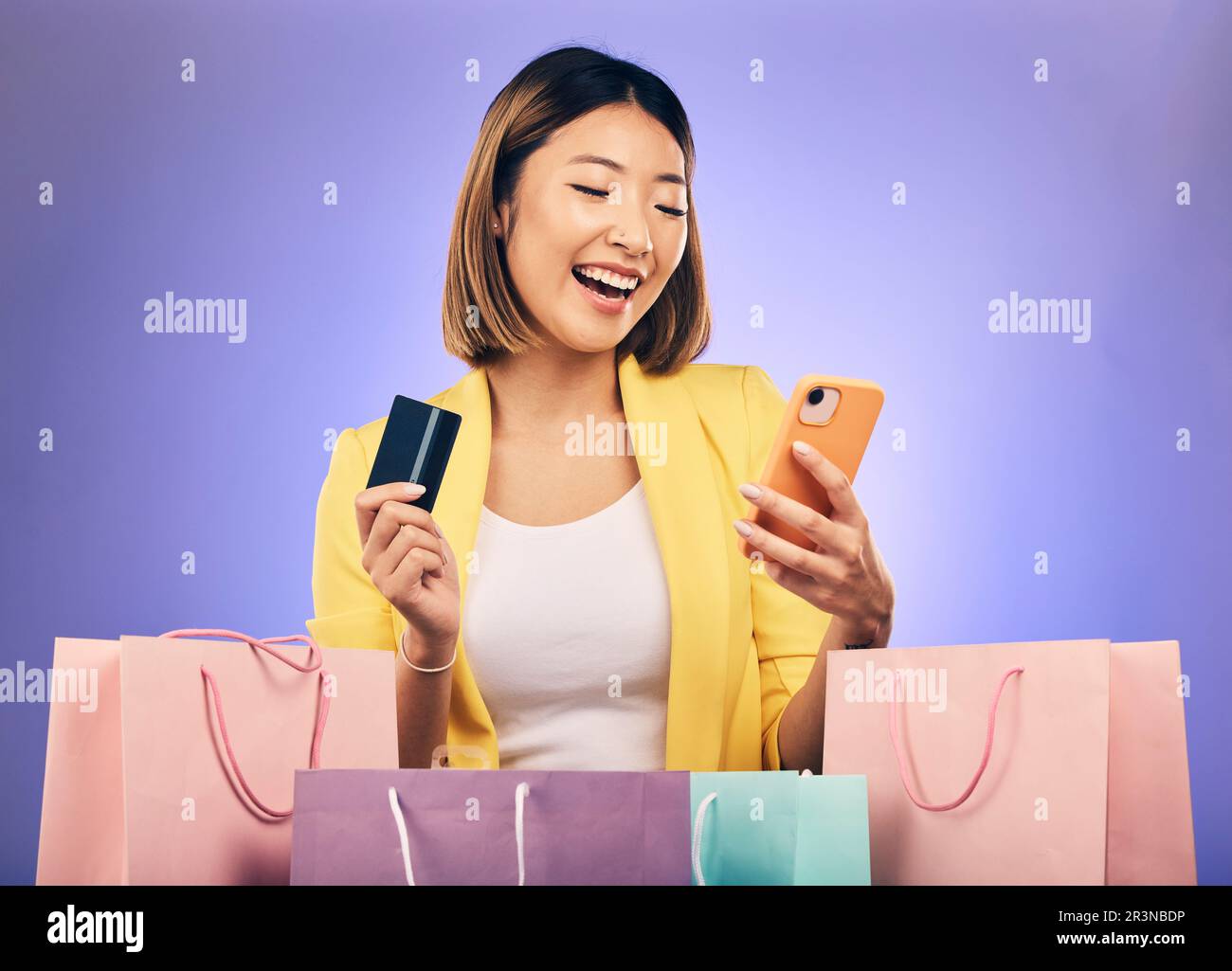 Japanese woman, credit card and shopping bag in studio with smile for deal, sale or discount ...