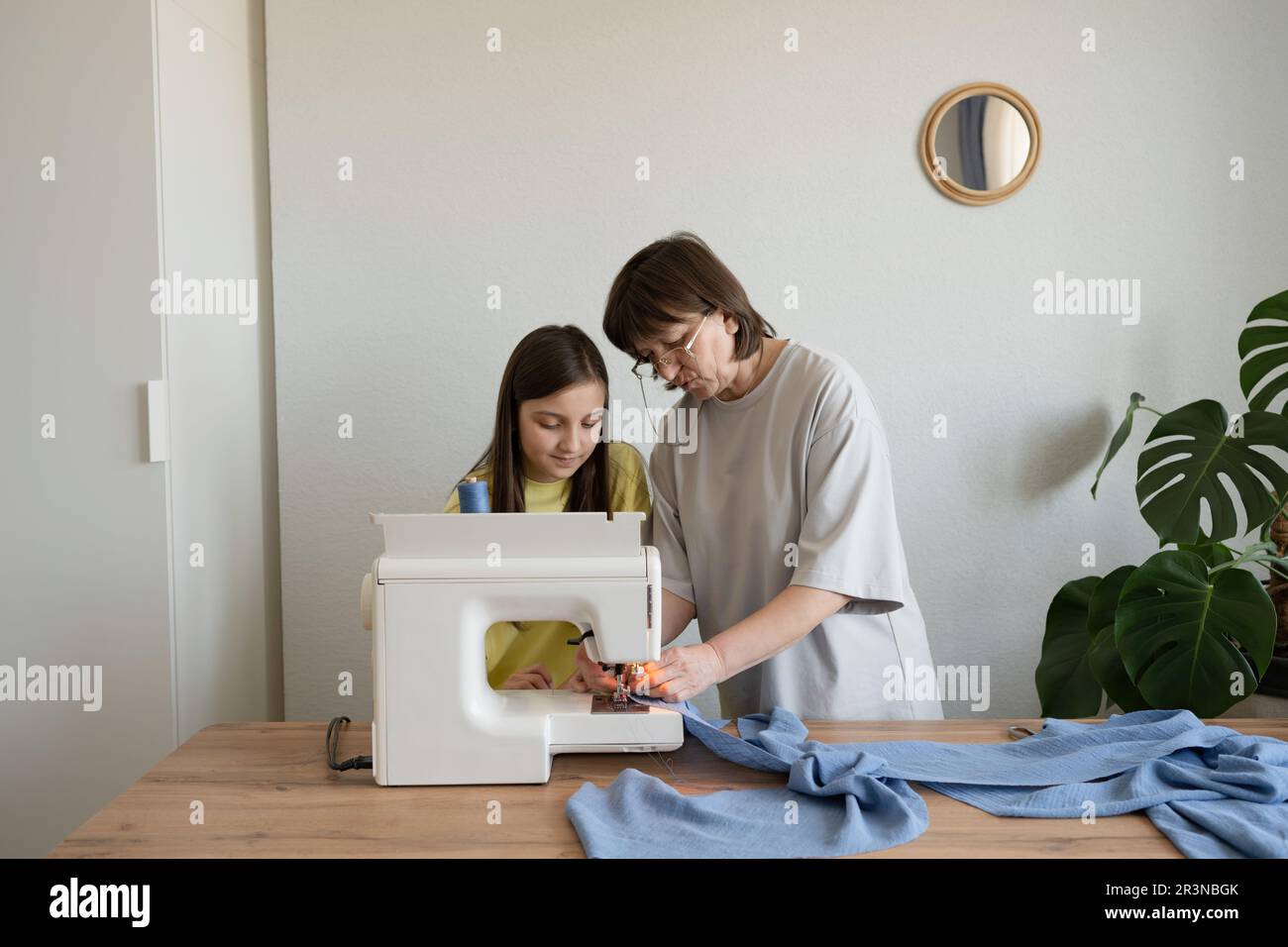 Dressmaker daughter sewing together in hi-res stock photography and ...