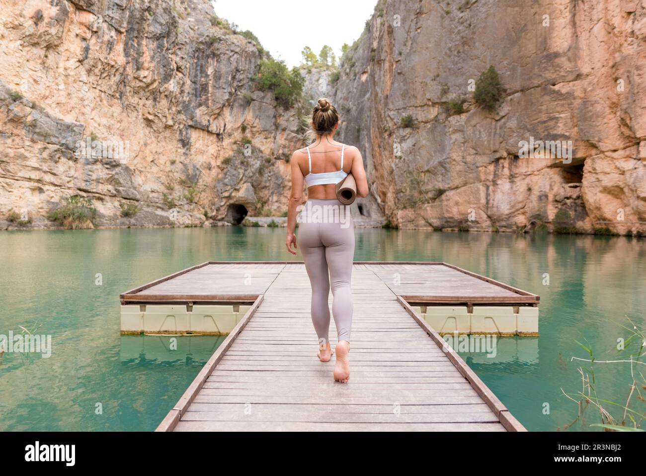 Full body back view of unrecognizable fit female in sportswear walking ...
