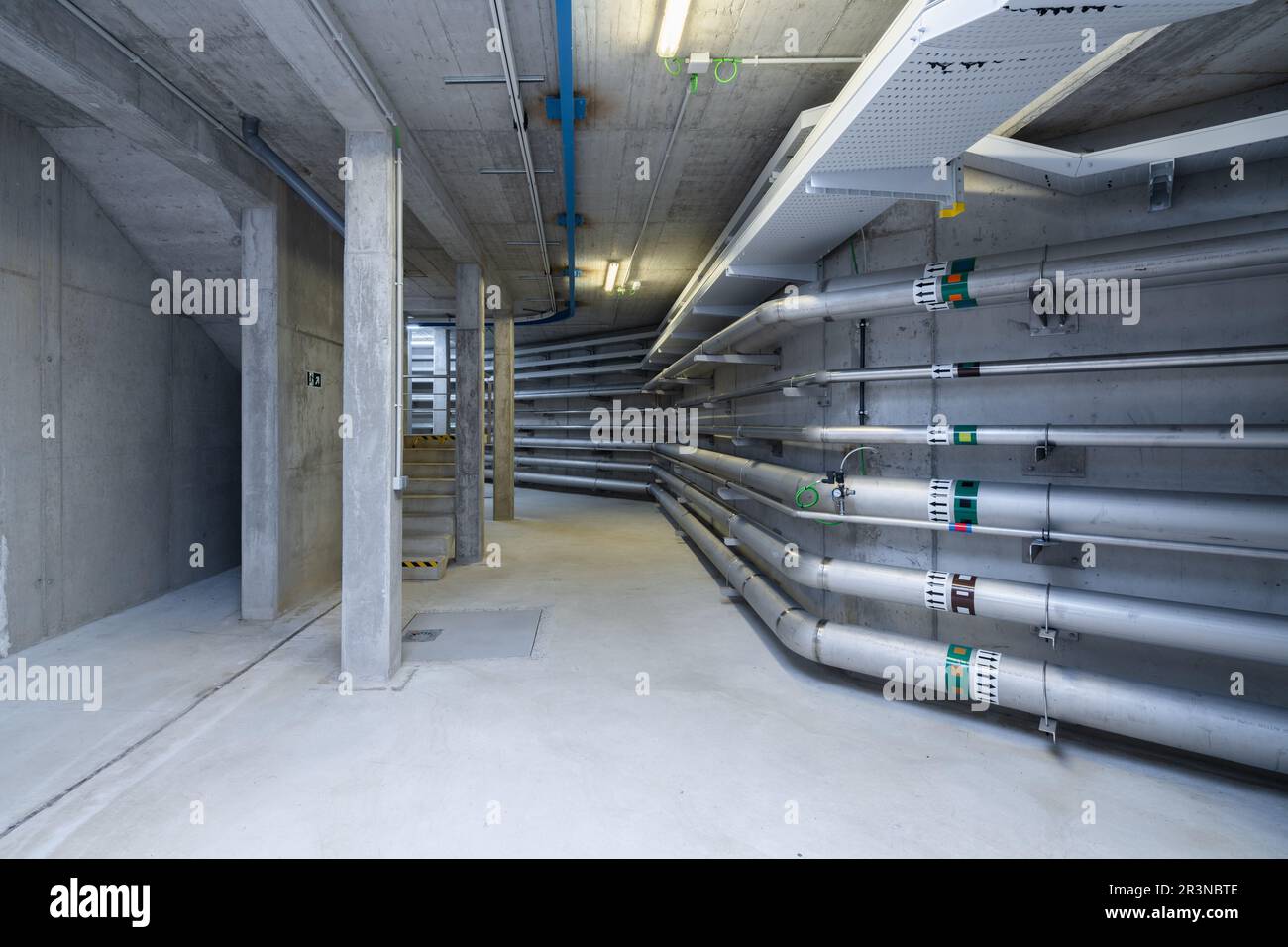 Empty basement of modern building with concrete columns and stairs with ...