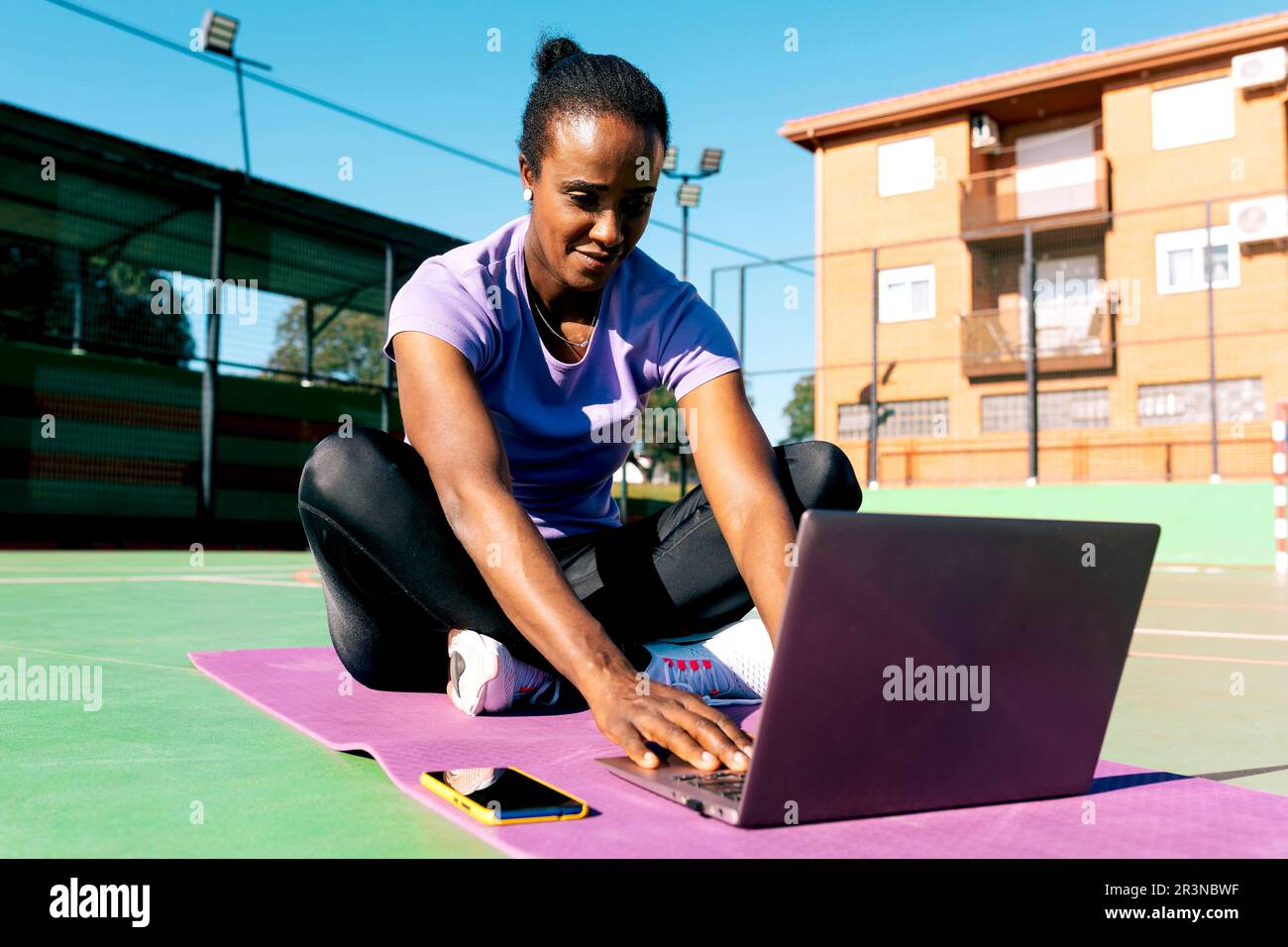 Full body of young fit African American female athlete in sportswear ...