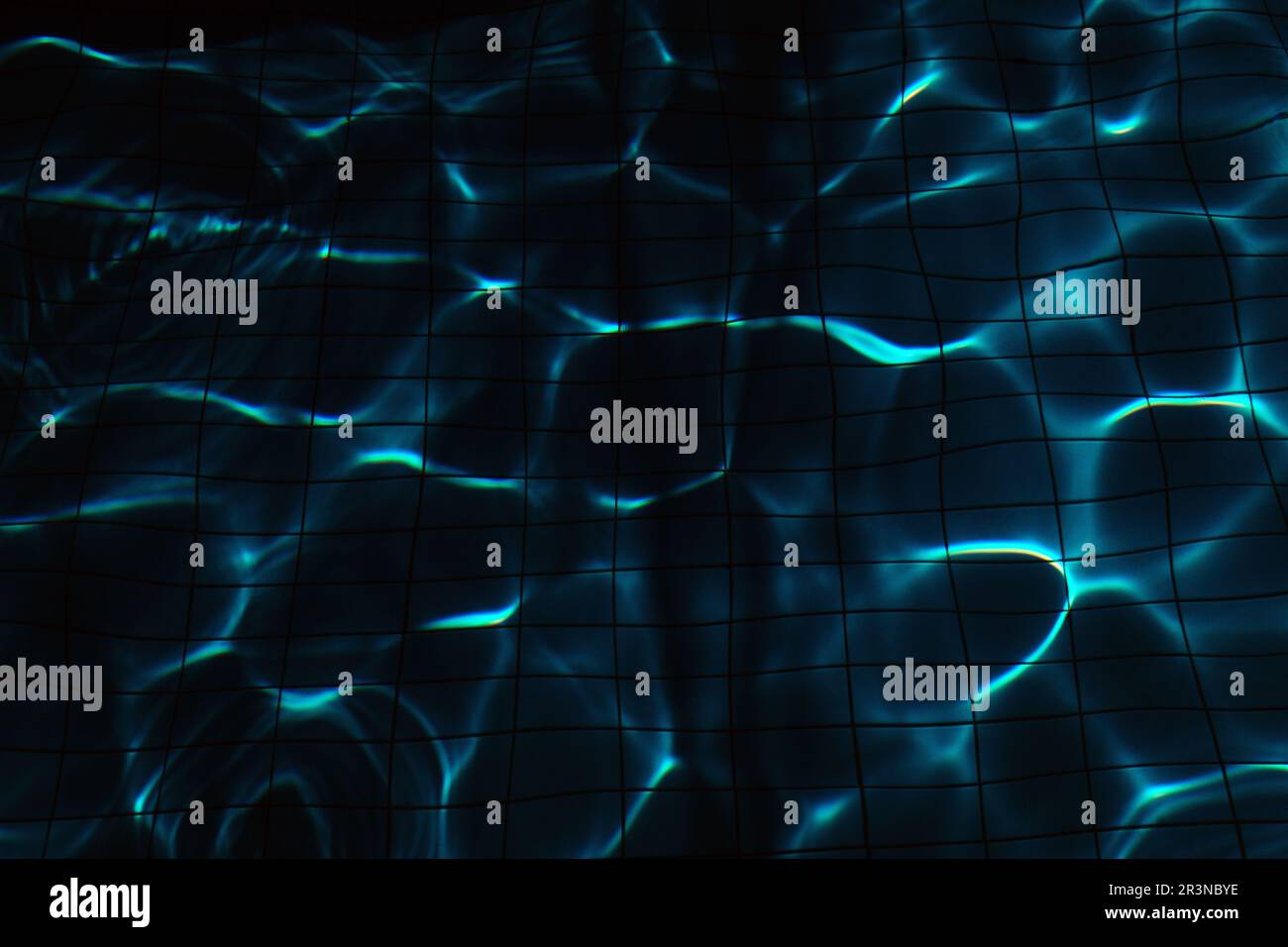 Top view of glowing lights reflecting on water surface in swimming pool ...