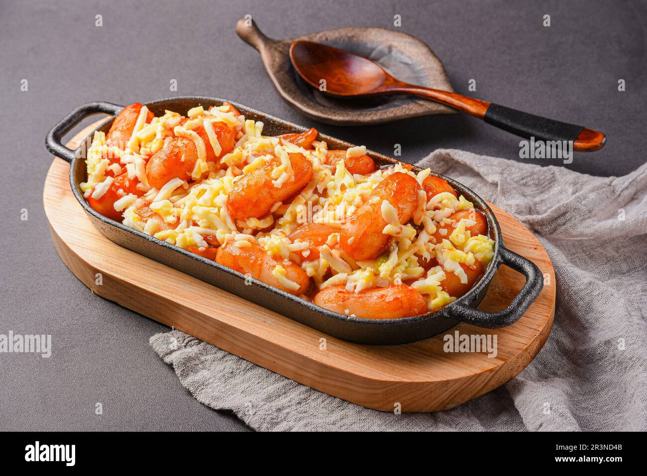 Korean rice cake stick with sausage in spicy sauce (Tteokbokki ...