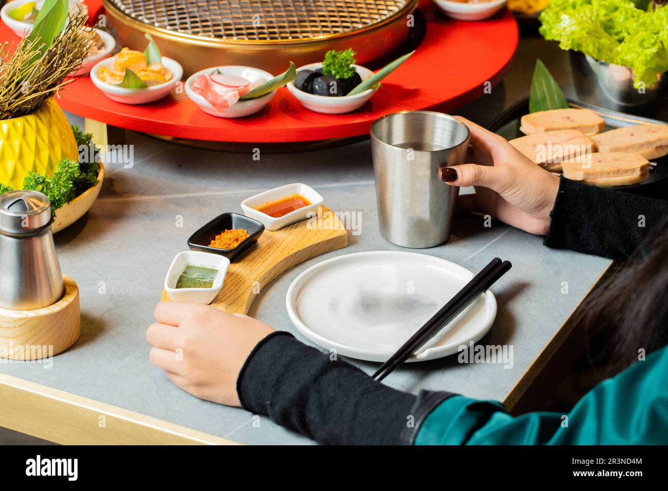 Young Asian man eating Korean Barbecue buffet ordering menu while ...