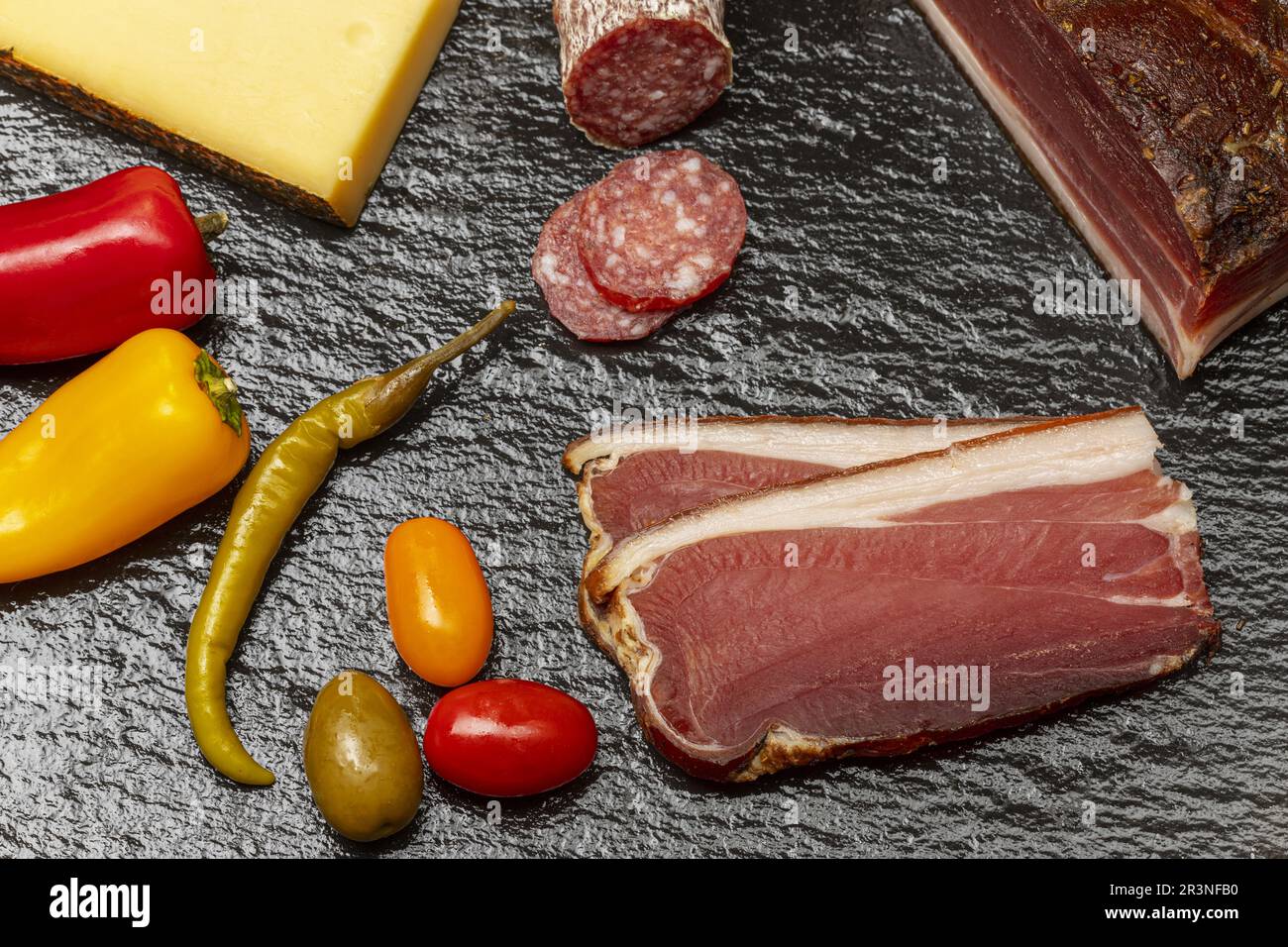 South Tyrolean bacon on slate Stock Photo - Alamy
