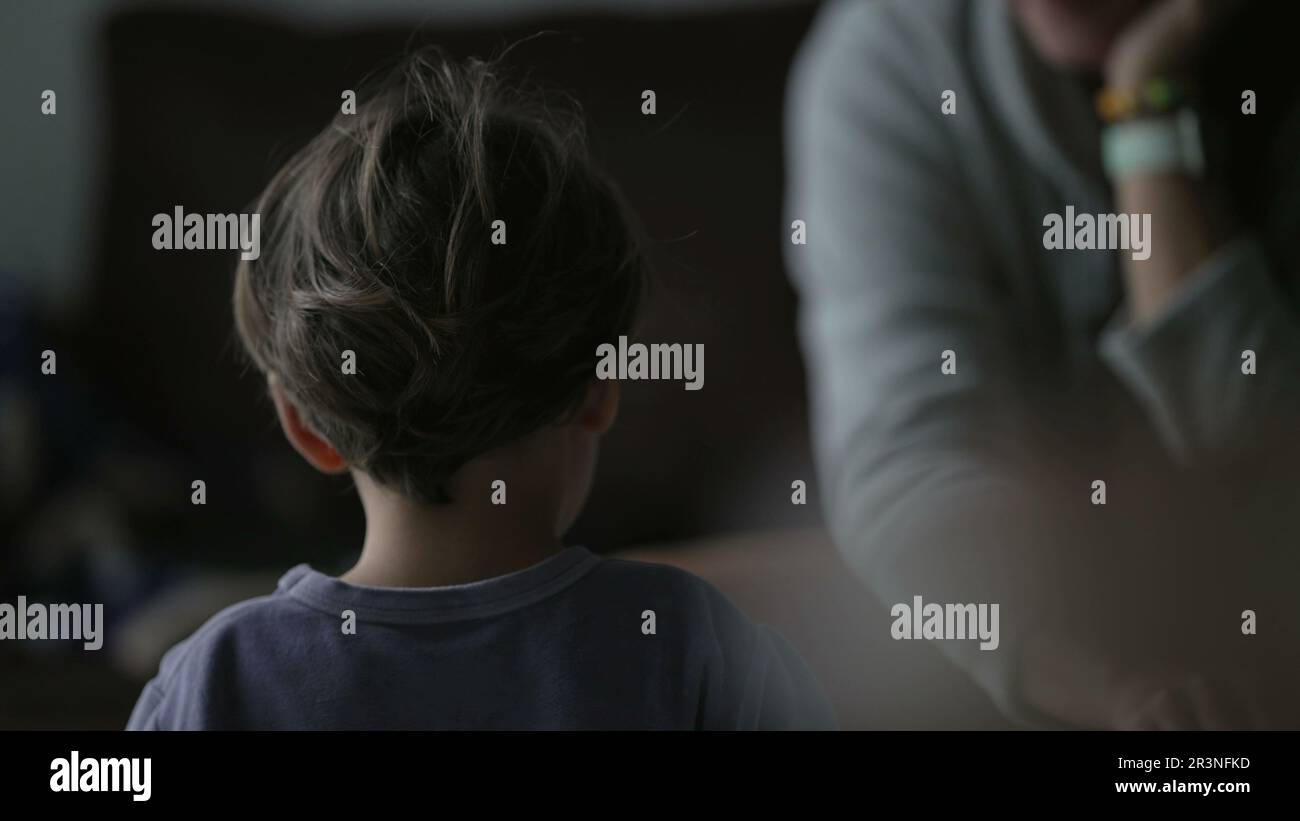 Back of child playing with mother board games at home. Childhood ...