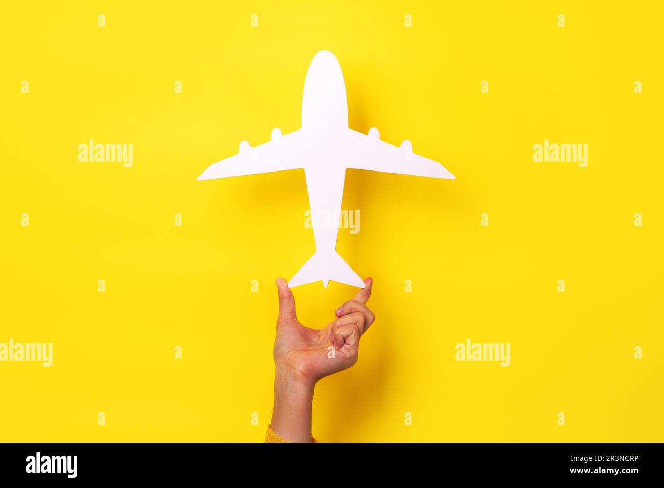 Hand holding airplane symbol Stock Photo - Alamy