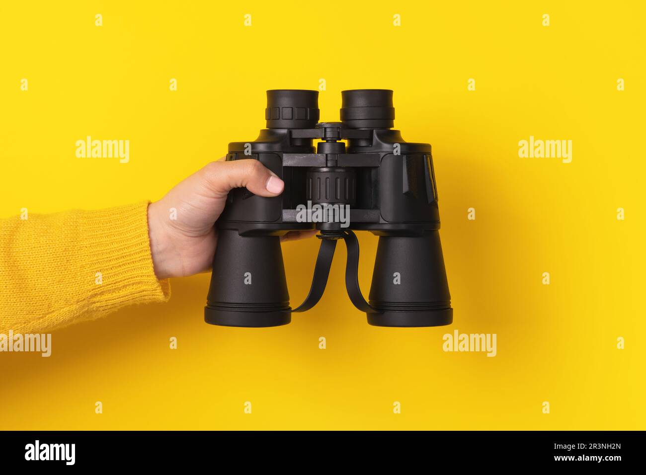 Hand holding binoculars Stock Photo - Alamy