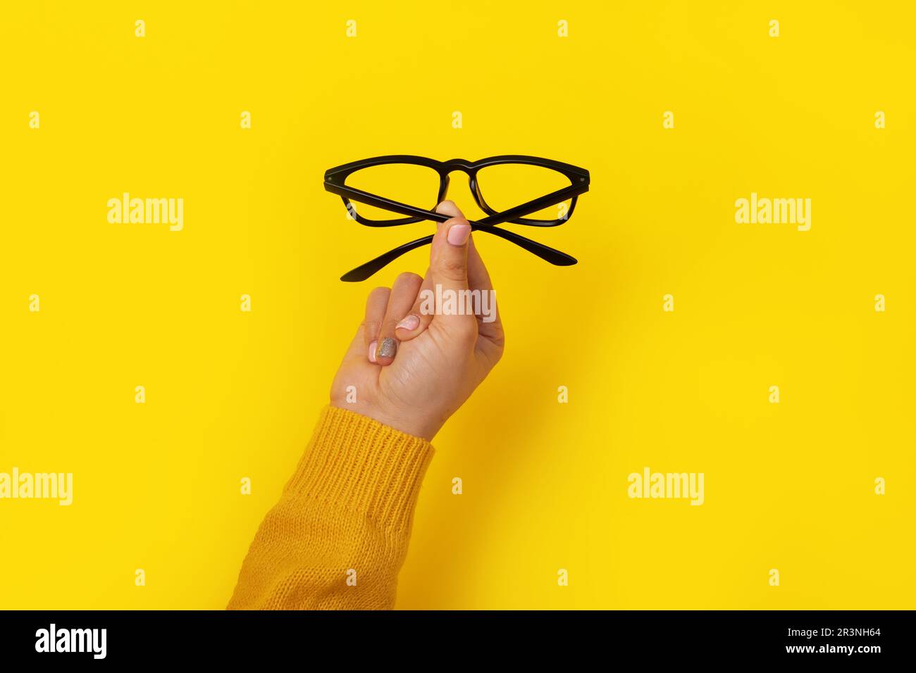 Hand holding glasses Stock Photo - Alamy