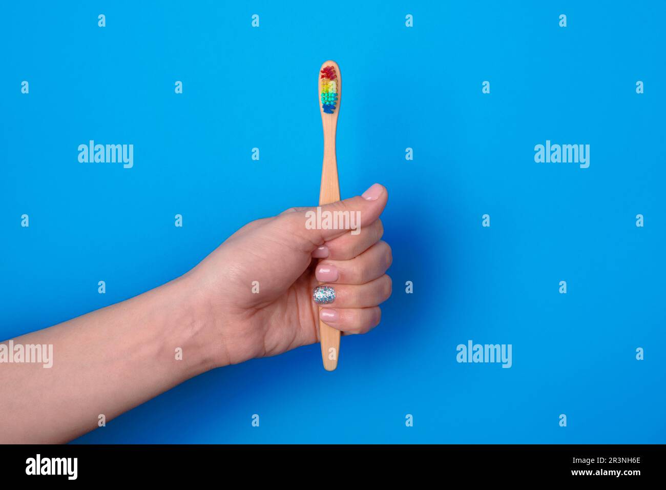 Hand holding bamboo toothbrush Stock Photo - Alamy