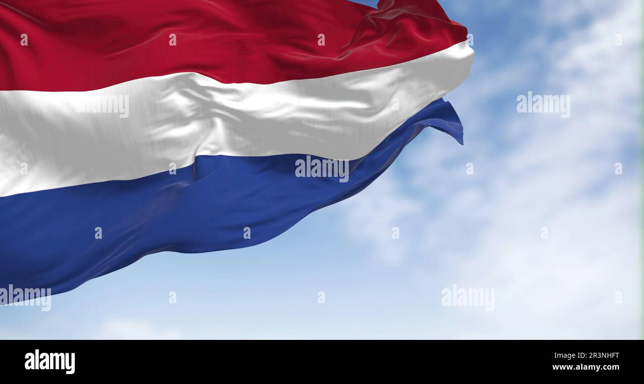 The national flag of the Netherlands waving in the wind on a sunny day ...