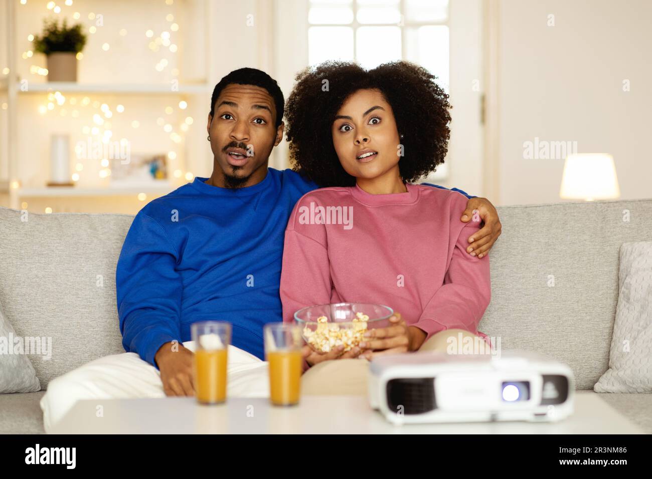 Black Couple Watching Horror Movie Using Home Cinema Projector Indoor ...