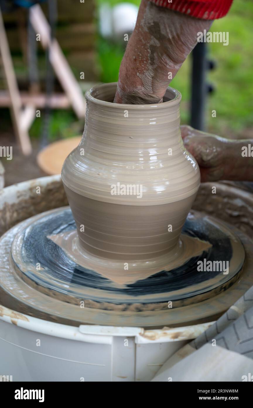 Making of mud pot on potters wheel during workshop outdoor in ...