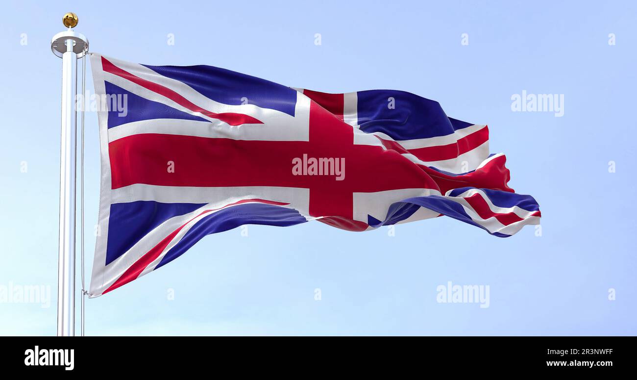 United Kingdom flag waving in the wind on a clear day Stock Photo - Alamy