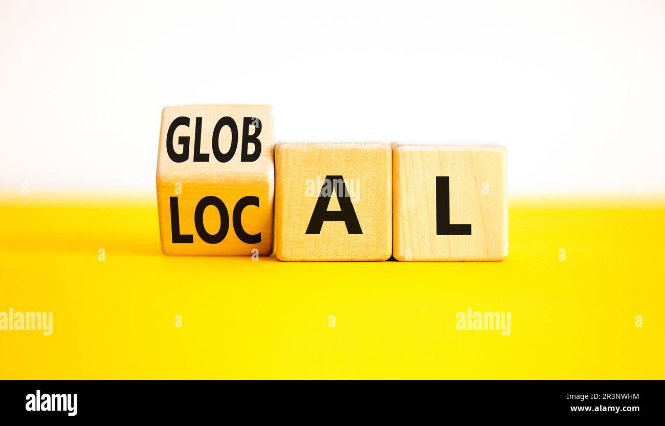 Local or global symbol. Businessman turns wooden cubes and changes the ...