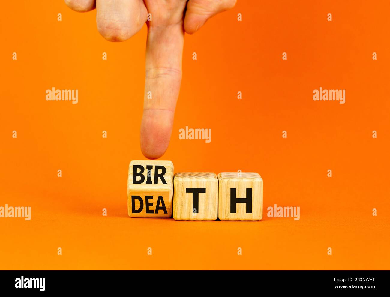 Birth or death symbol. Businessman turns wooden cubes and changes the ...