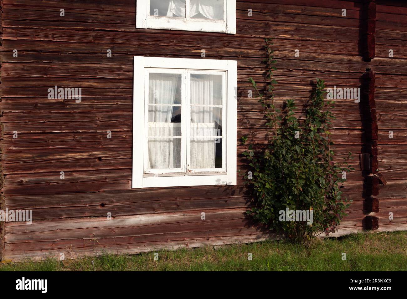 Closeup of red painted logs on the wall of a building. Ancient ...