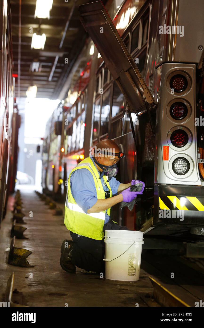 Allen Kong, electrical transit mechanic, cleans the traction motor and ...