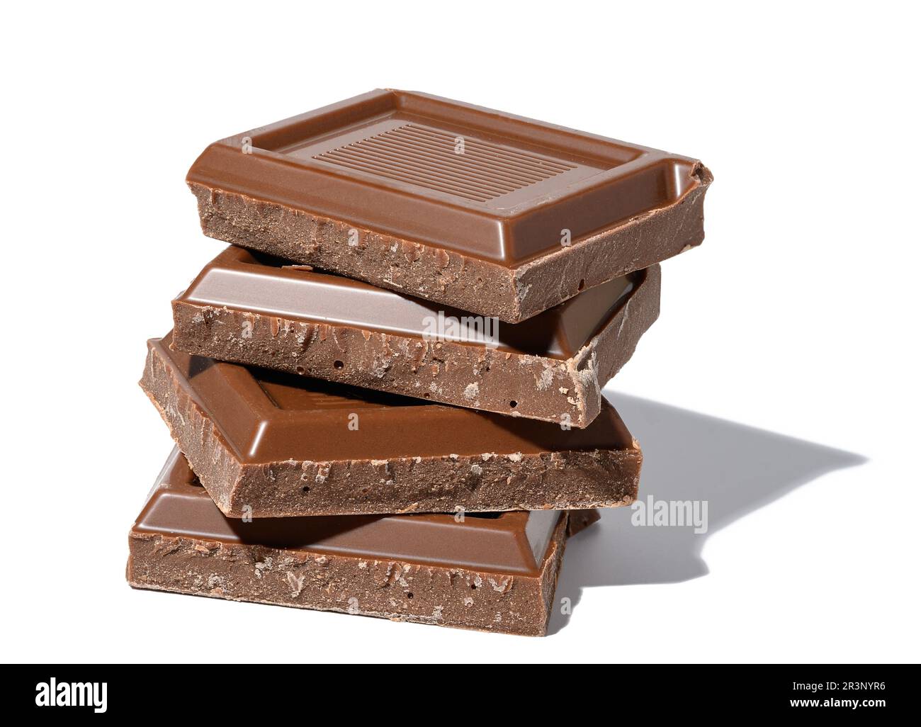 A stack of broken milk chocolate on a white isolated background, square ...
