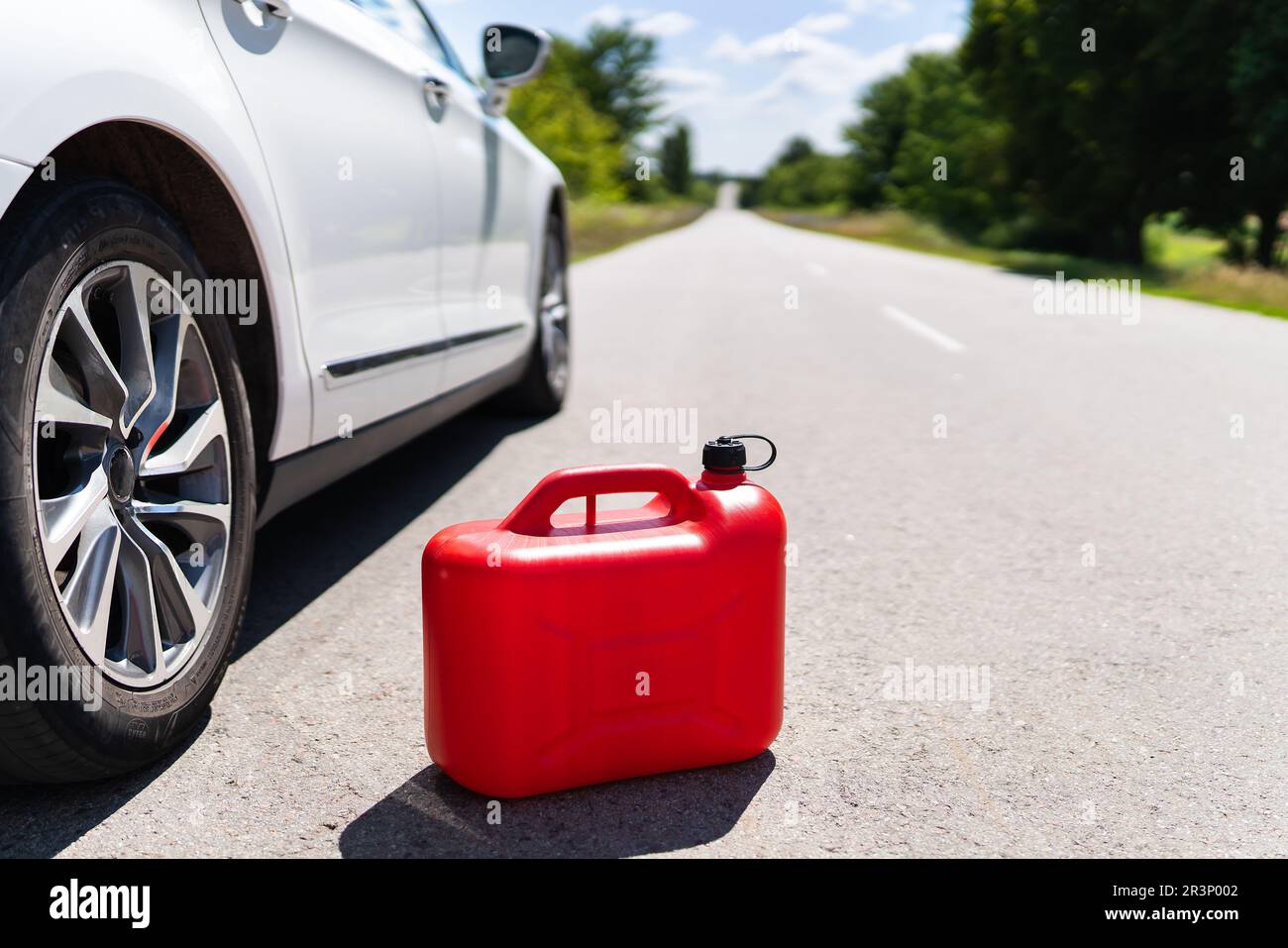 Empty car tank from a red canister on the side of the road. Fuel ...