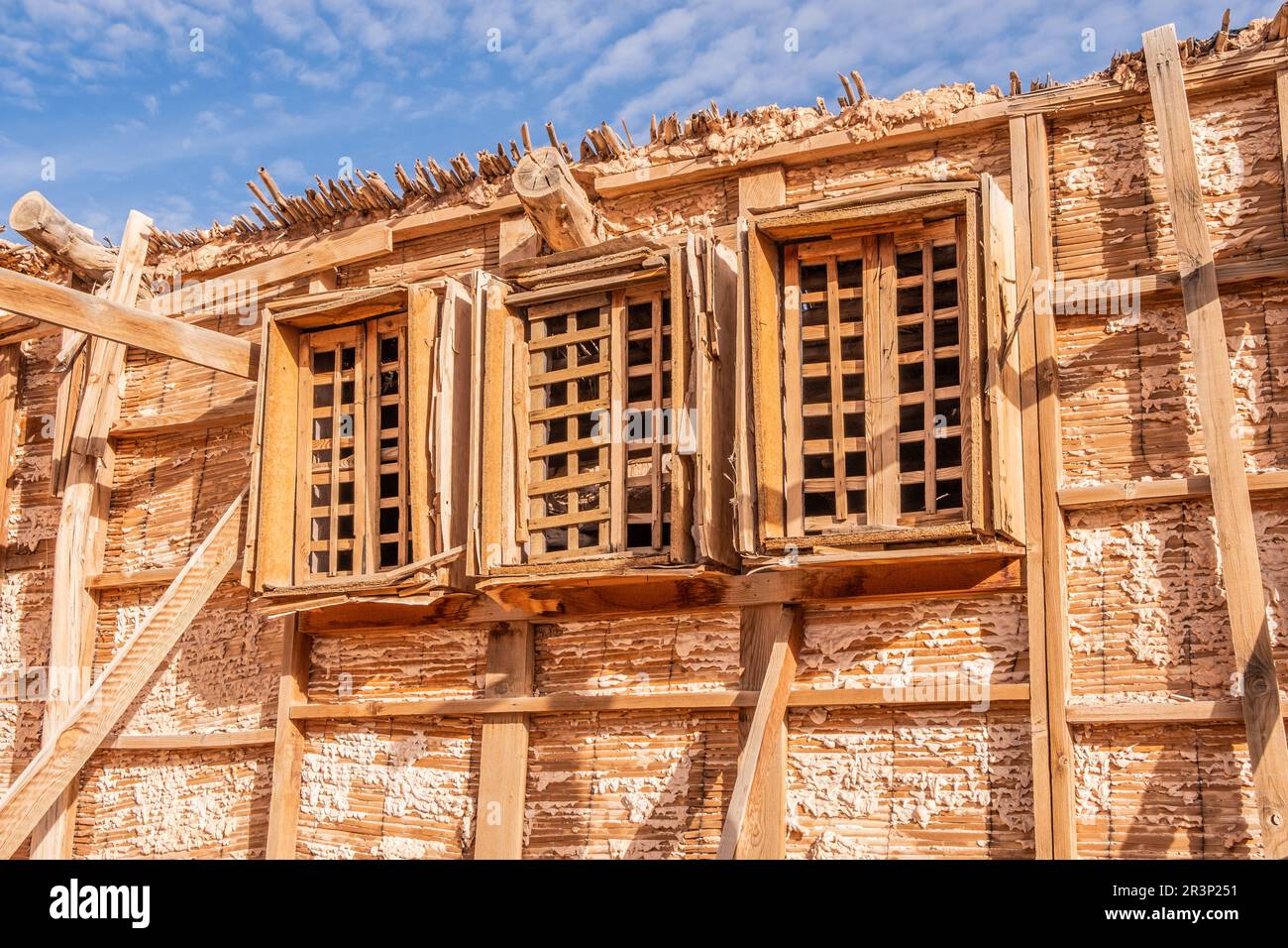 House built with thin light wood slats with a blue sky Stock Photo - Alamy
