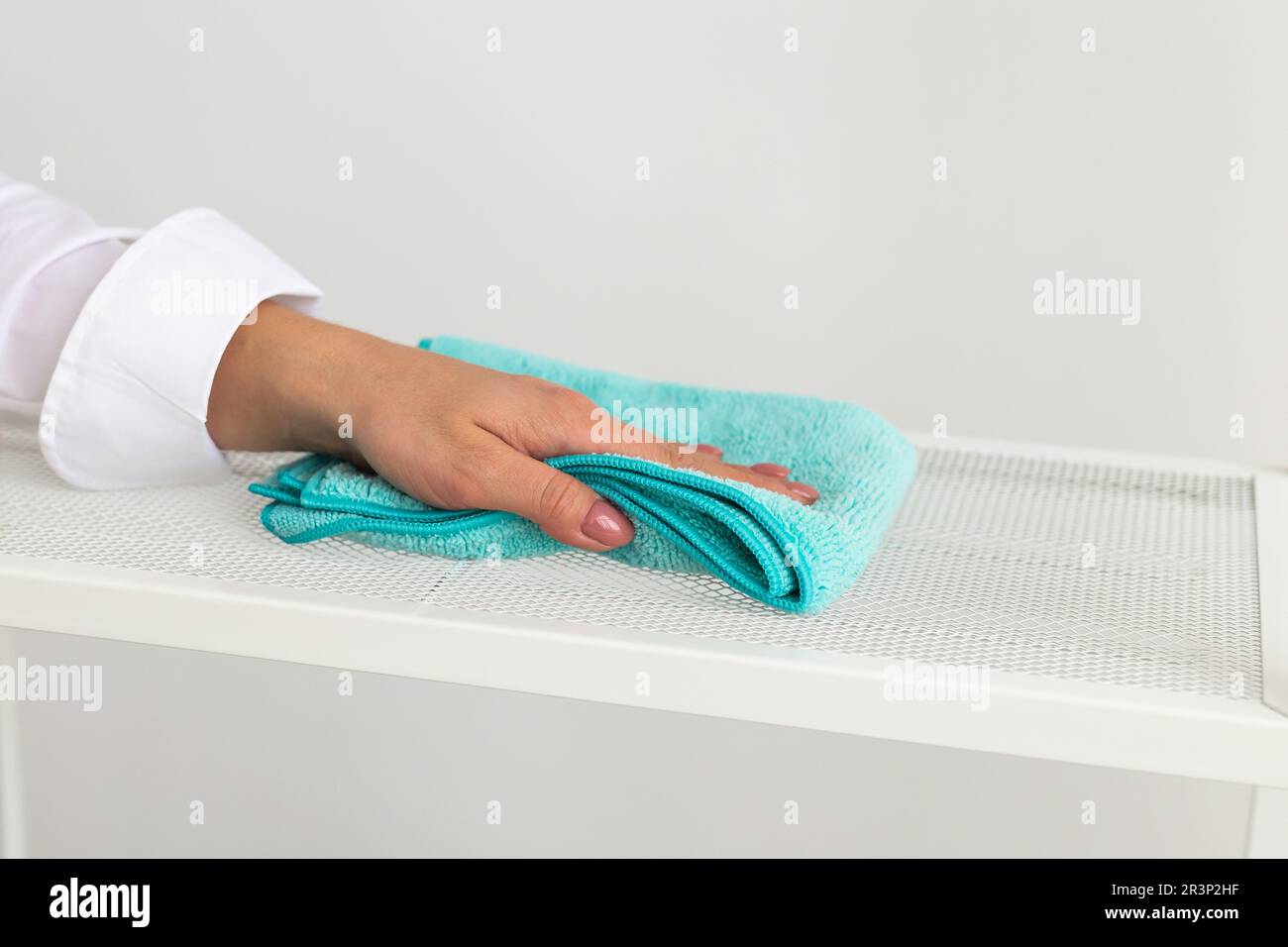 Woman wiping shelf indoors hi-res stock photography and images - Alamy