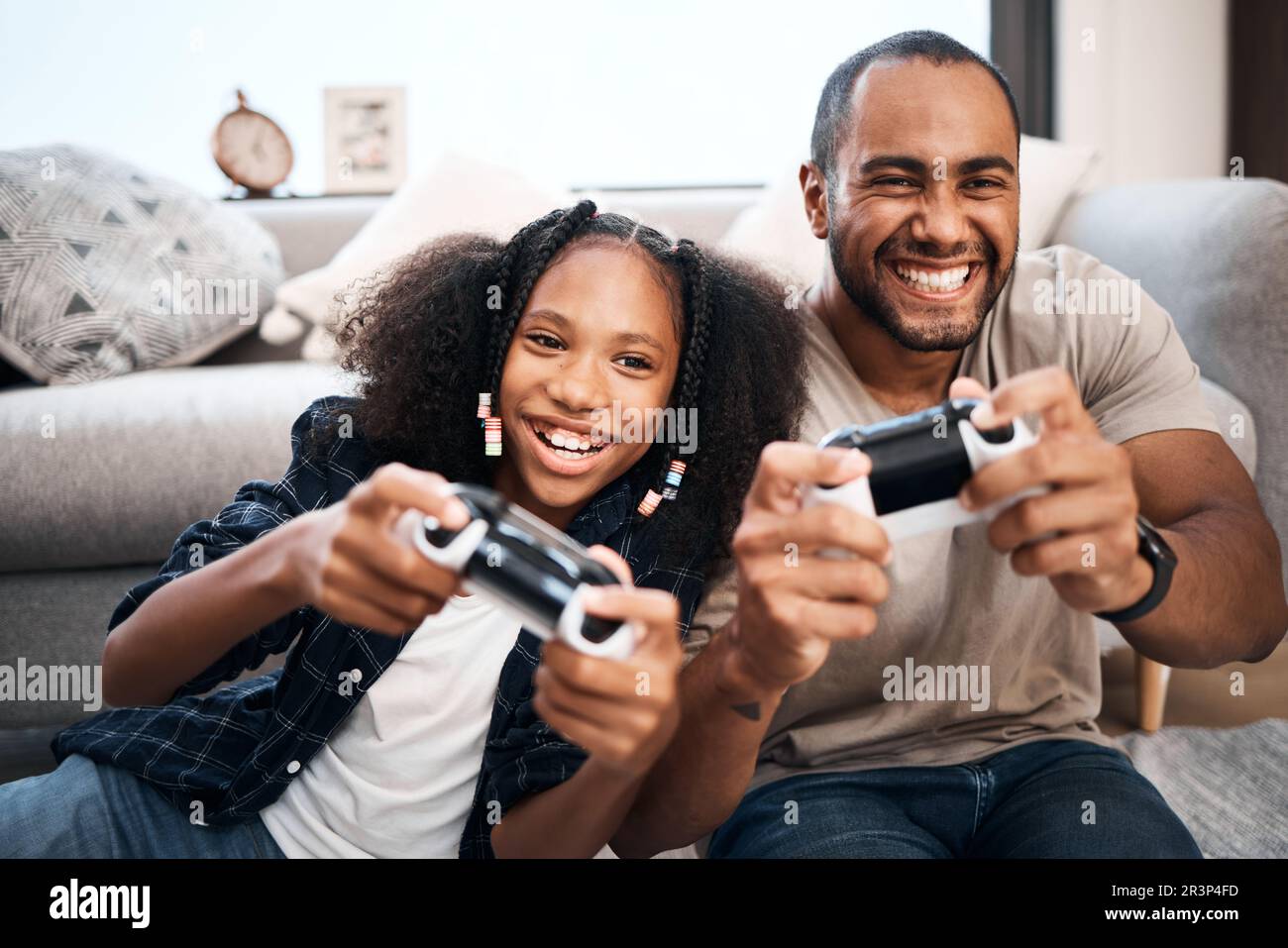 Gaming, family or children with a father and daughter in the living ...