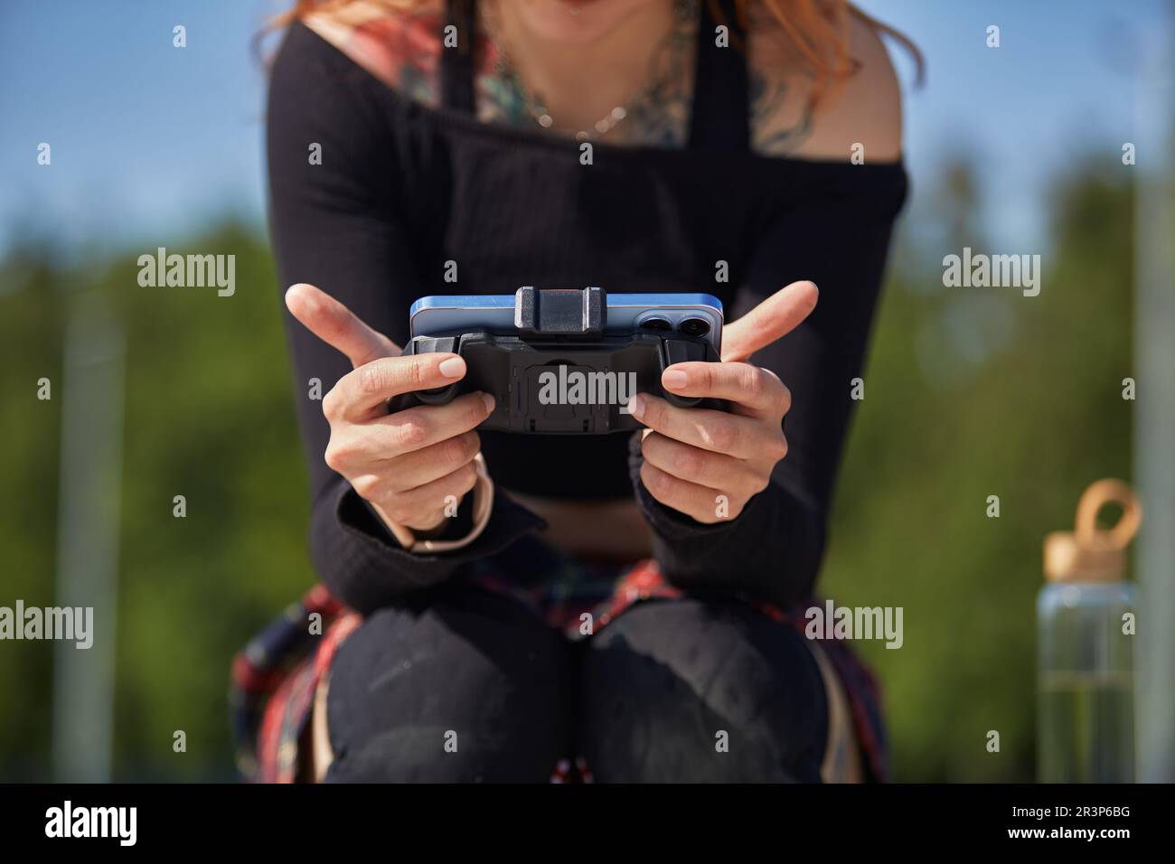 Gamer girl playing online video games on a mobile phone. Young female ...