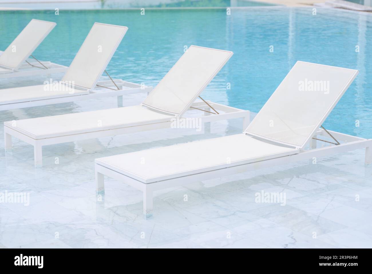 Chairs in swimming pool at luxury hotel, Summer vacation at poolside ...