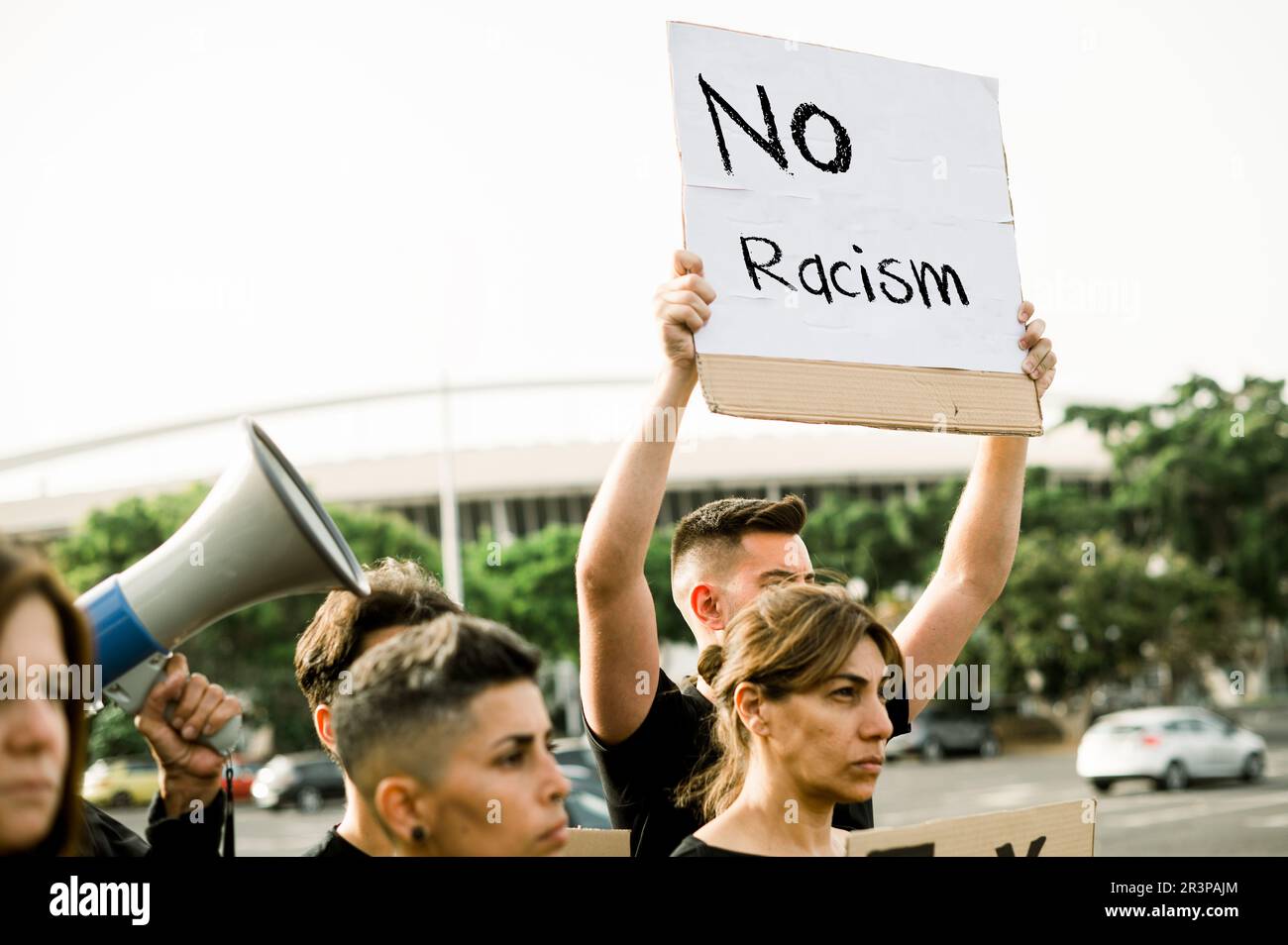 group of demonstrators with loudspeaker in the street protesting racism ...