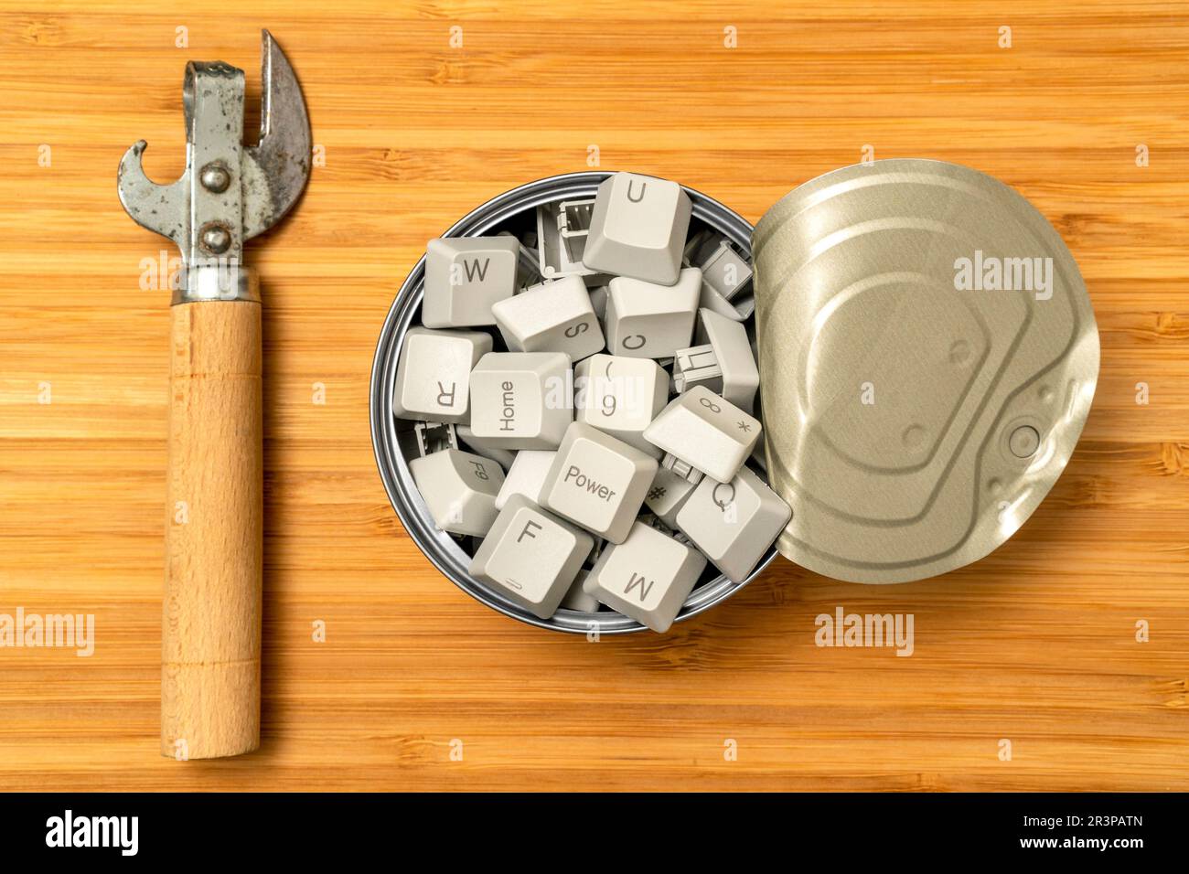 Can opener and tin can full of computer keyboard keys Stock Photo - Alamy