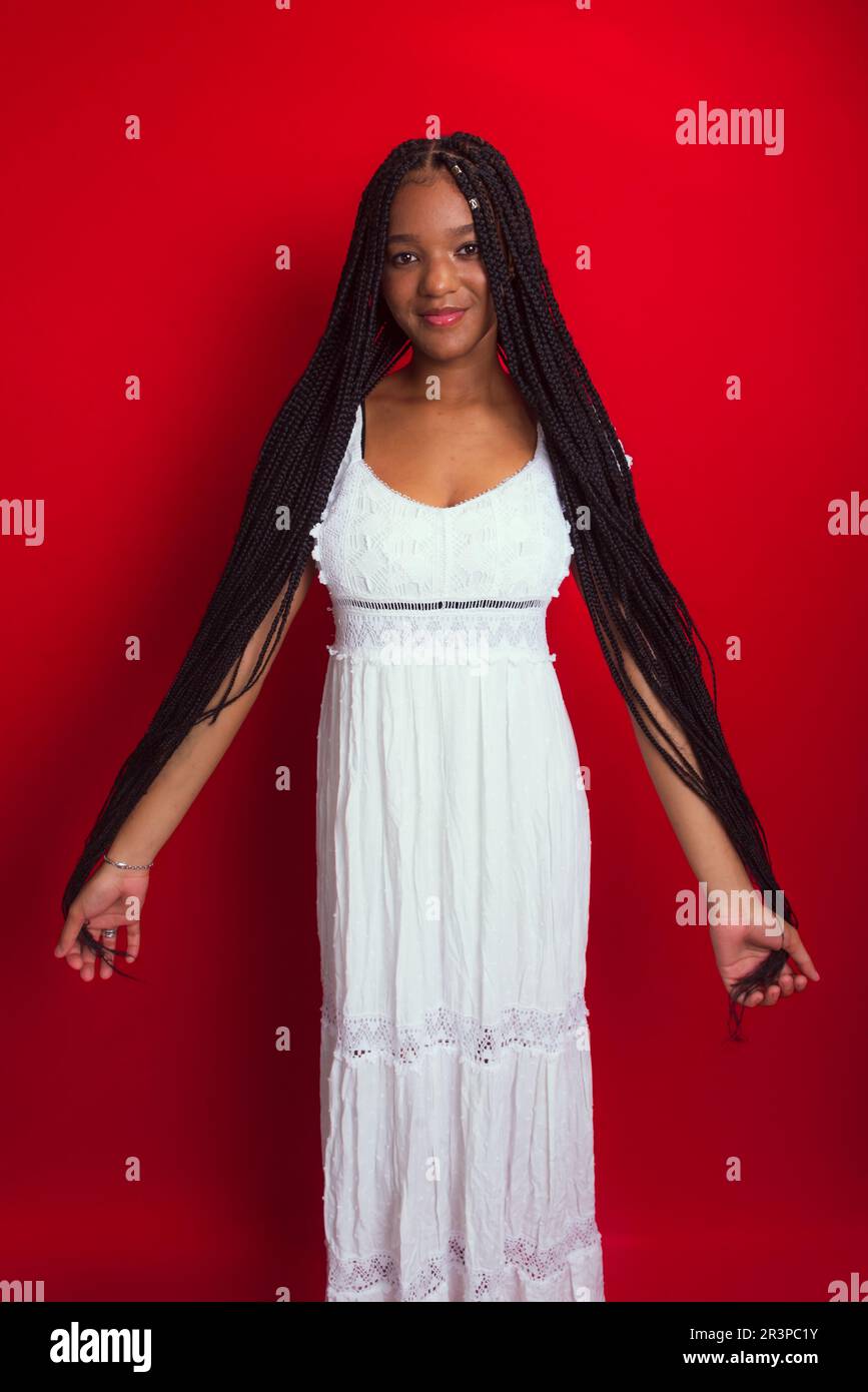 Portrait of young, beautiful woman, standing, messing with her hair ...